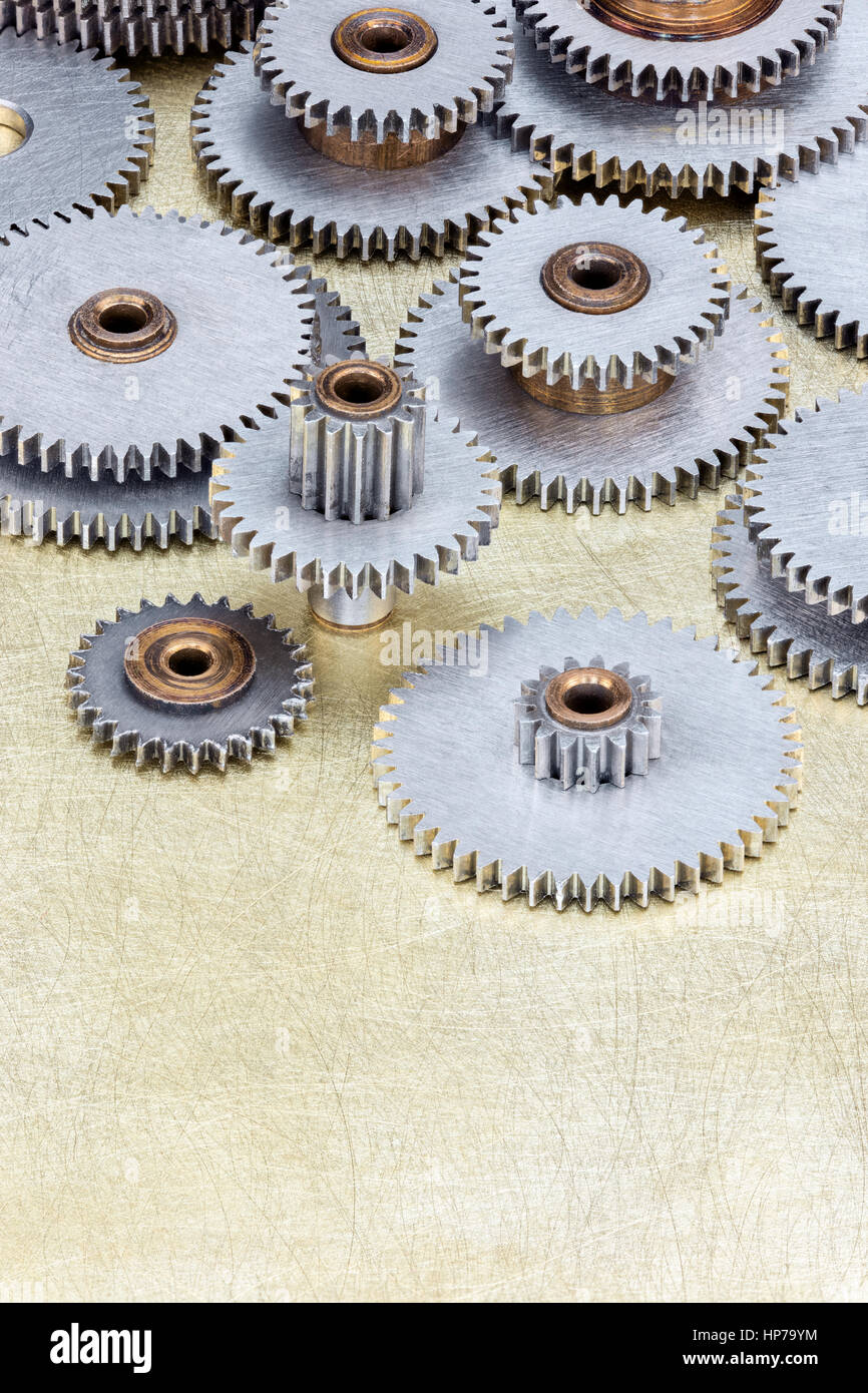 set of different gear cogwheel on brass metal background closeup Stock ...