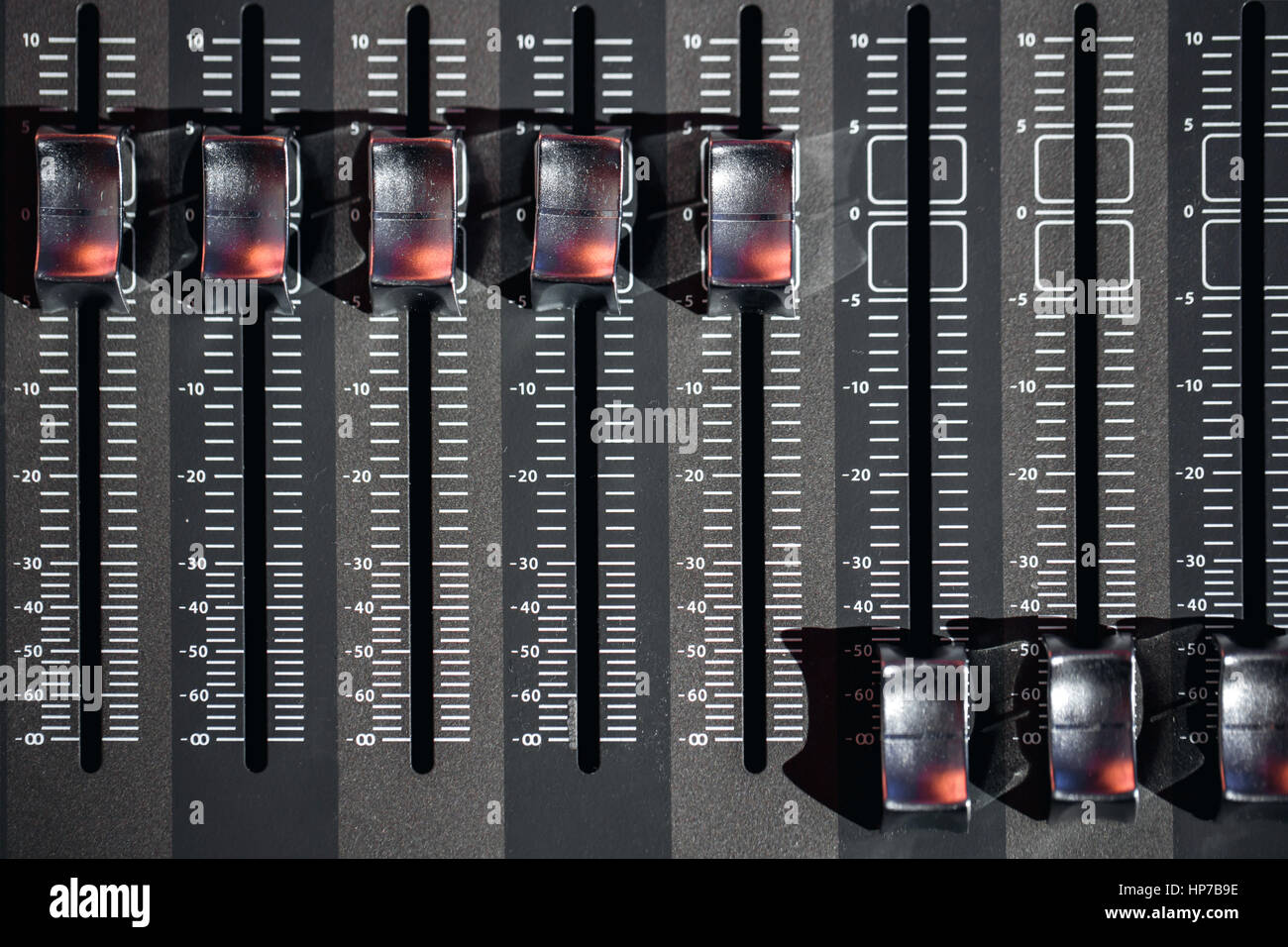 Top view od adjusters and red buttons of a mixing console. It is used ...