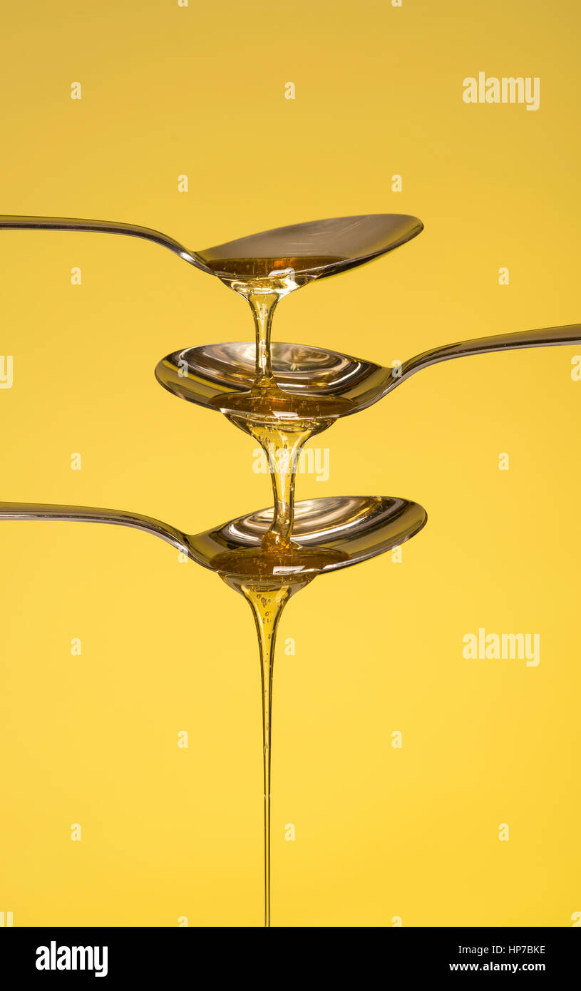 Pouring over three spoons Stock Photo - Alamy