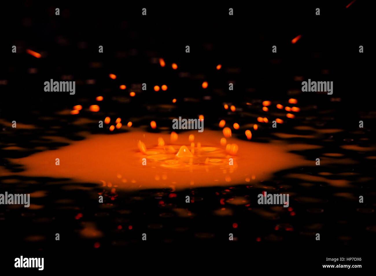 Colorful paint drop splashing on black a background Stock Photo - Alamy