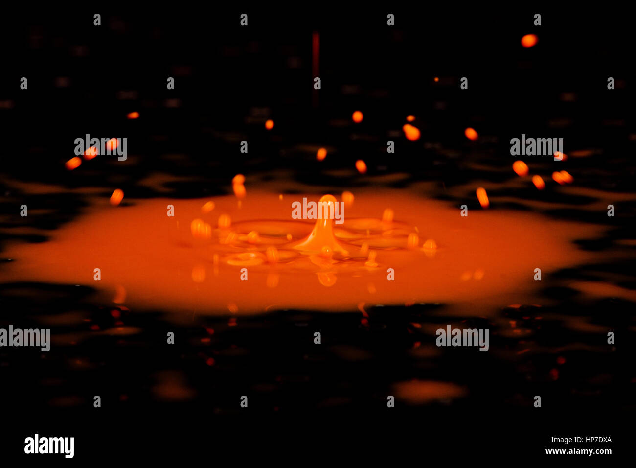 Colorful paint drop splashing on black a background Stock Photo - Alamy