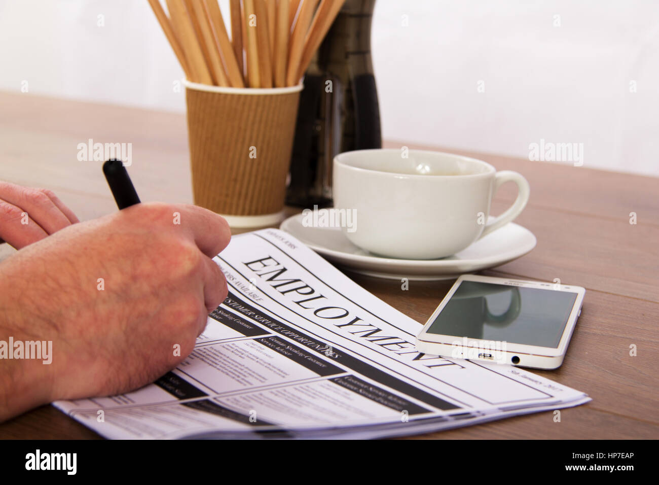 Searching for a new job or employment in a newspaper Stock Photo - Alamy