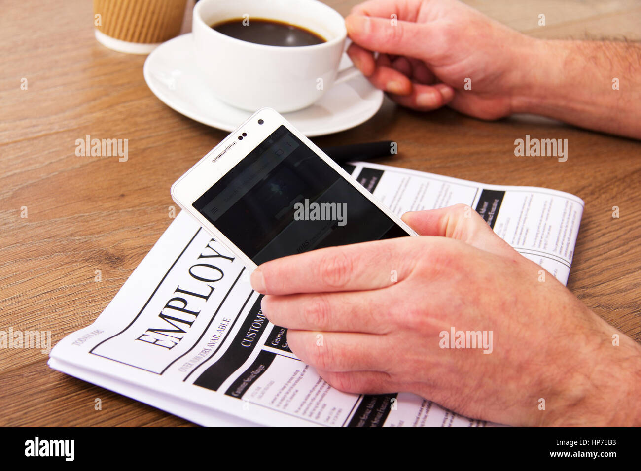 Searching for a new job or employment in a newspaper Stock Photo - Alamy