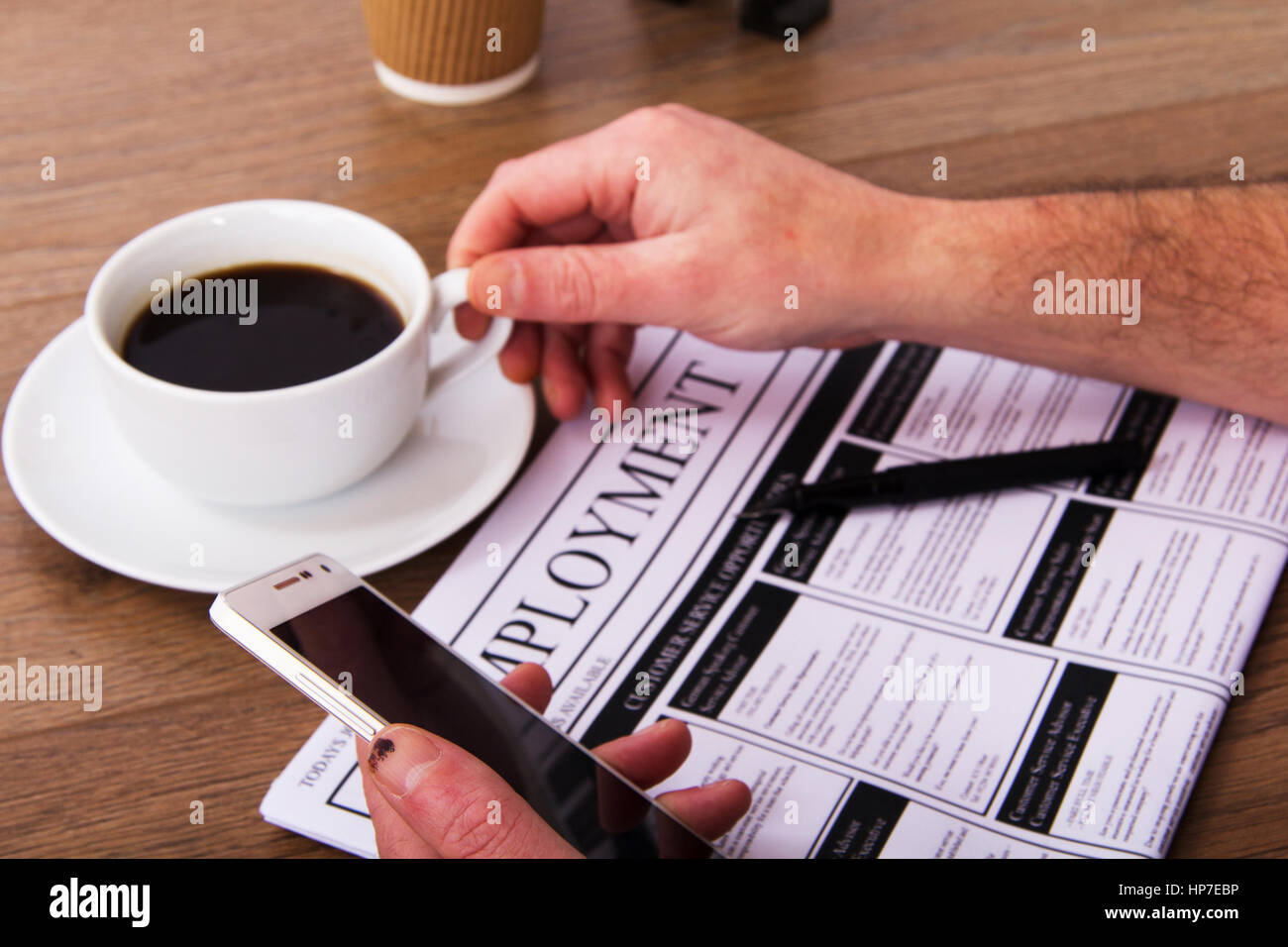 Searching for a new job or employment in a newspaper Stock Photo - Alamy