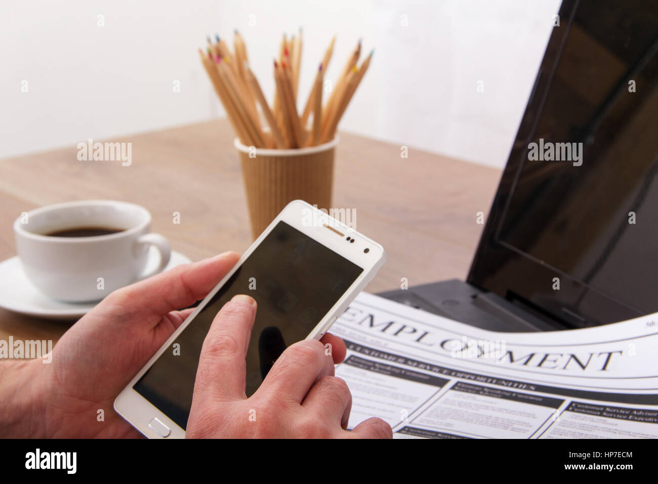 Searching for a new job or employment in a newspaper Stock Photo - Alamy