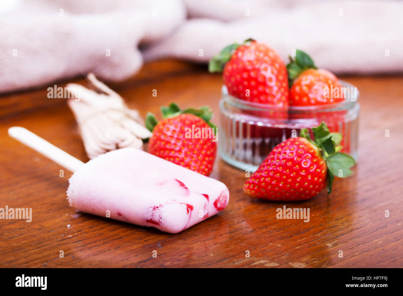 Homemade strawberry ice lolly on a rustic background Stock Photo - Alamy