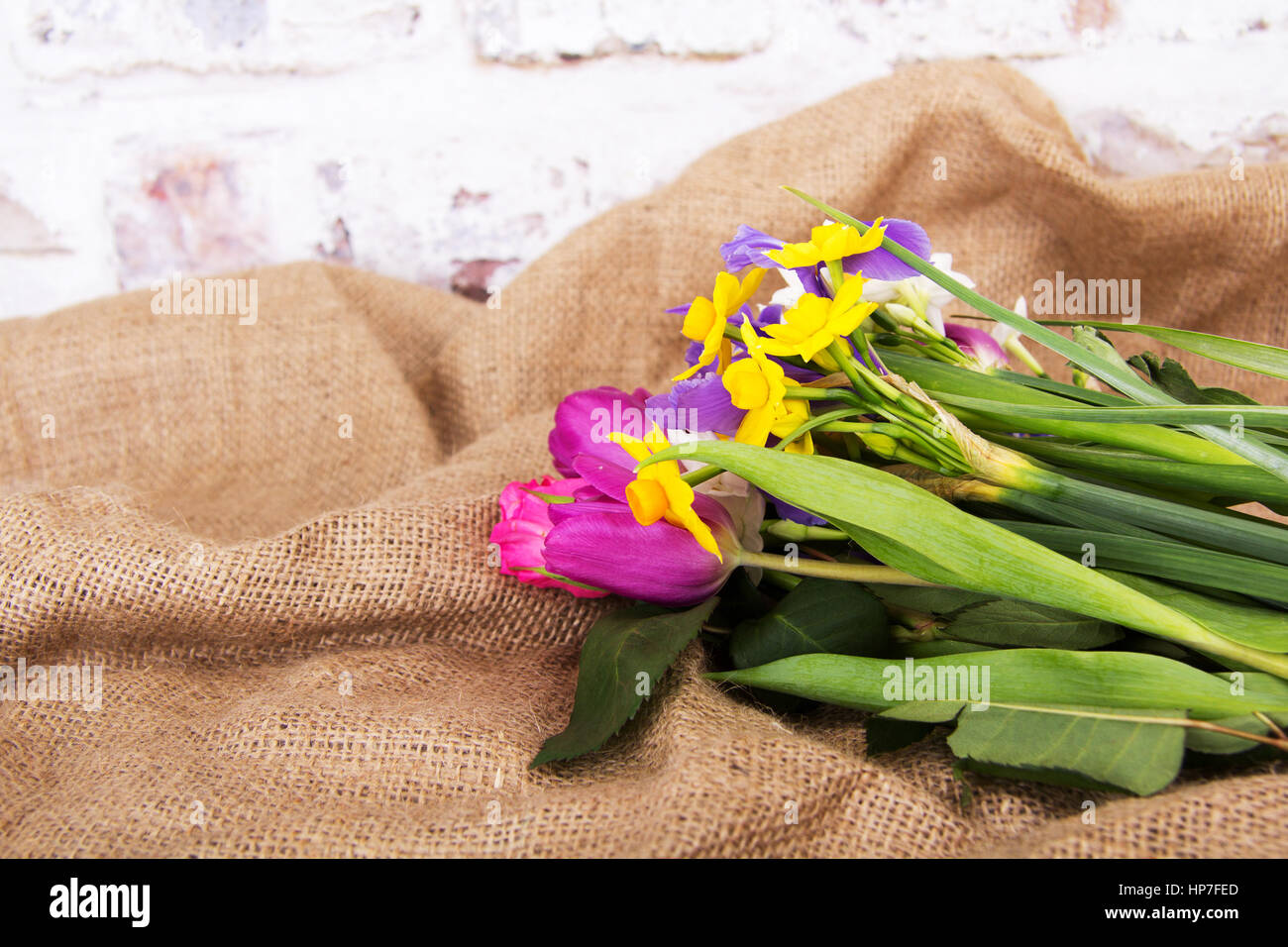 Spring cut flower arrangement against a rustic background Stock Photo ...