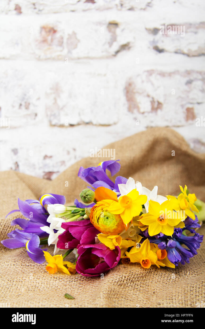 Spring cut flower arrangement against a rustic background Stock Photo ...