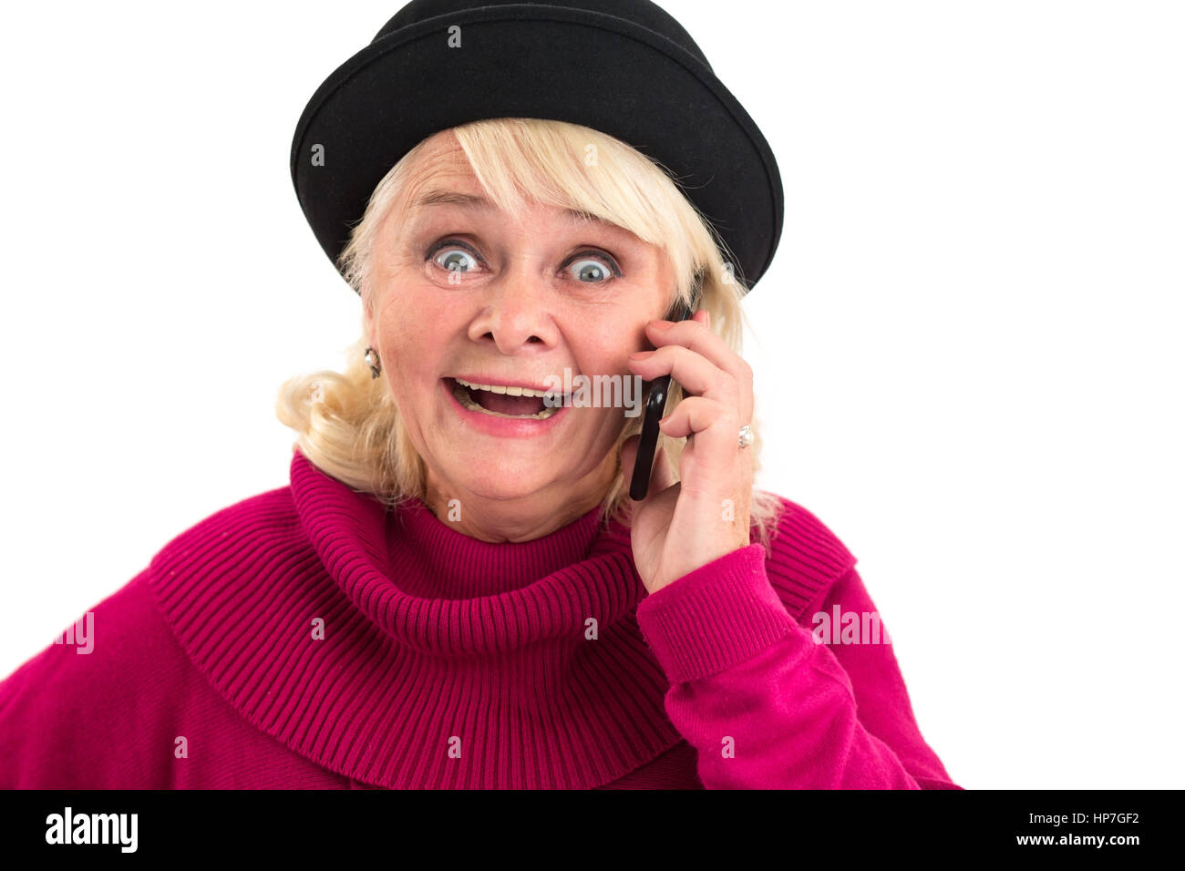 Surprised lady holding cell phone. Senior woman on white background ...