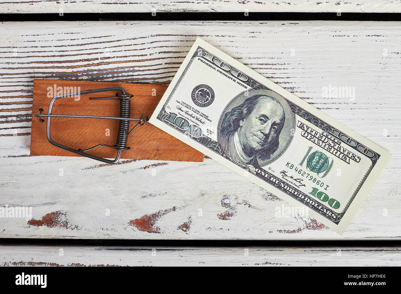 Mousetrap and dollars on wood. Money is trap for soul Stock Photo - Alamy