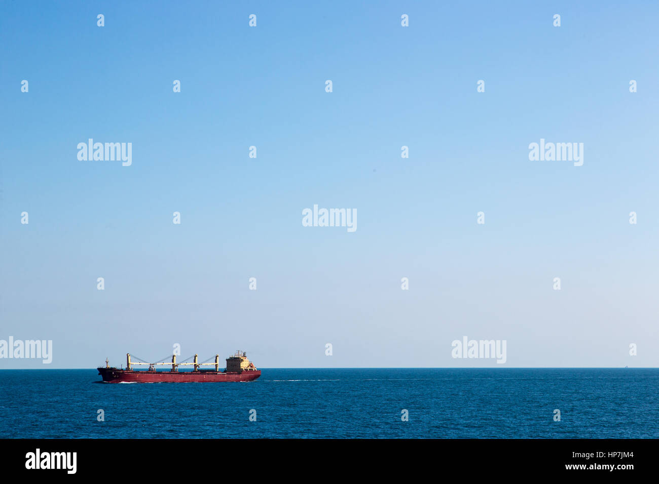 Cargo ship at sea, space for text Stock Photo - Alamy