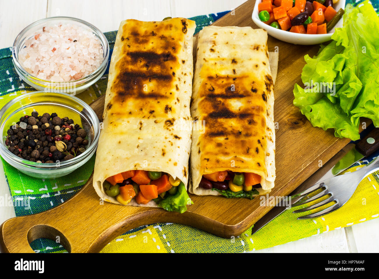 Buritos for Mexican on wooden cutting board. Studio Photo Stock Photo ...