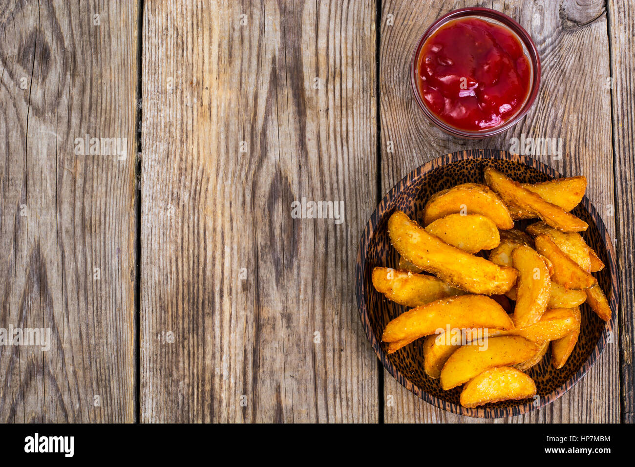 Potato wedges in rural on wood. Studio Photo Stock Photo - Alamy