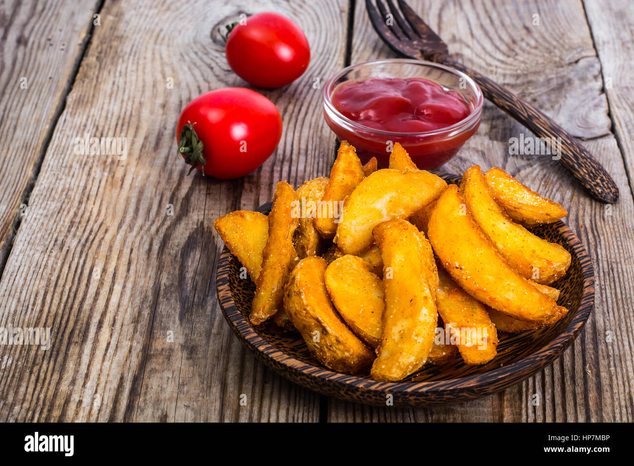 Potato wedges in rural on wood. Studio Photo Stock Photo - Alamy
