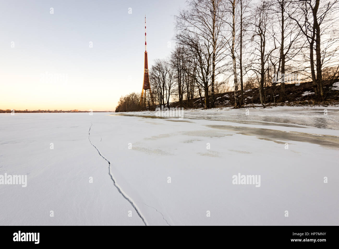 frozen beach in cold winters day with colorful sky and ice with TV ...