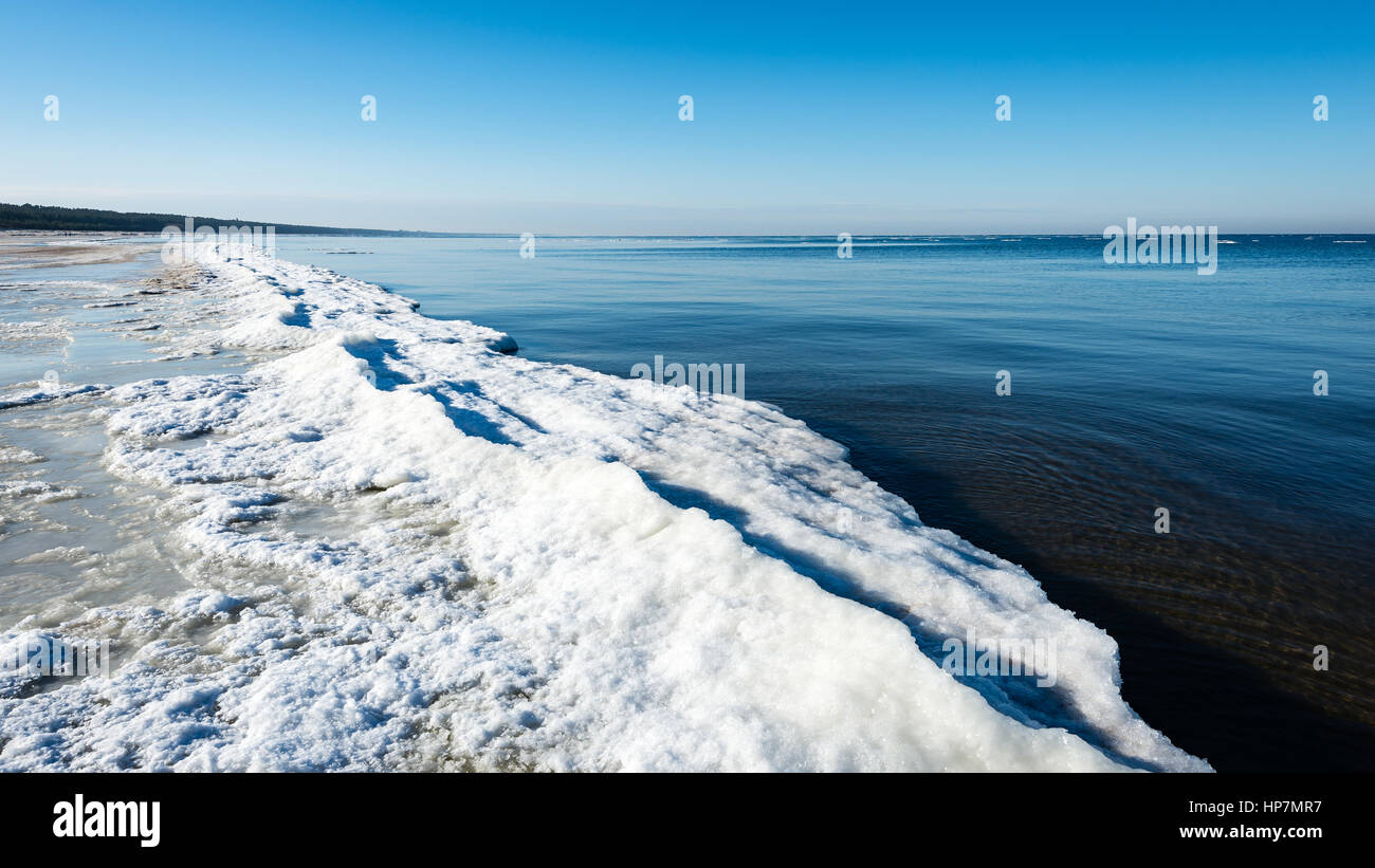 frozen beach in cold winters day with colorful sky and ice Stock Photo ...