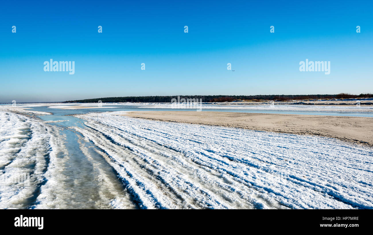 frozen beach in cold winters day with colorful sky and ice Stock Photo ...