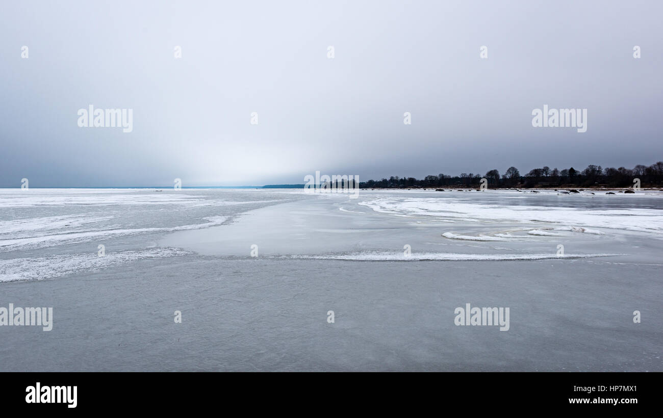 frozen beach in cold winters day with colorful sky and ice Stock Photo ...
