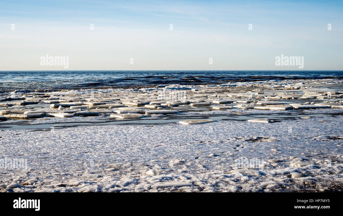 frozen beach in cold winters day with colorful sky and ice Stock Photo ...
