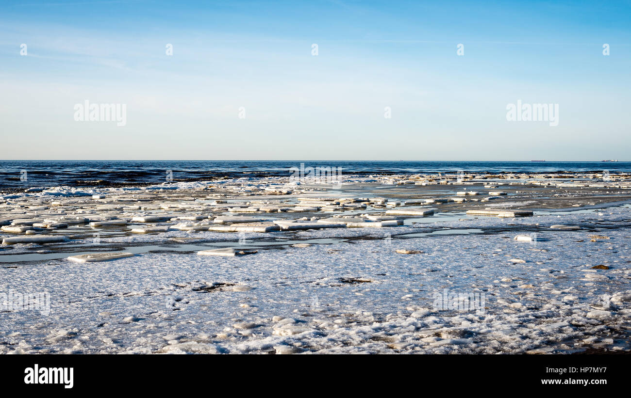 frozen beach in cold winters day with colorful sky and ice Stock Photo ...