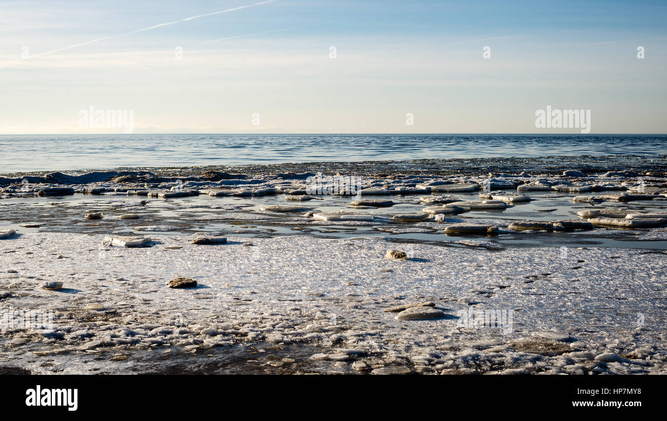 frozen beach in cold winters day with colorful sky and ice Stock Photo ...