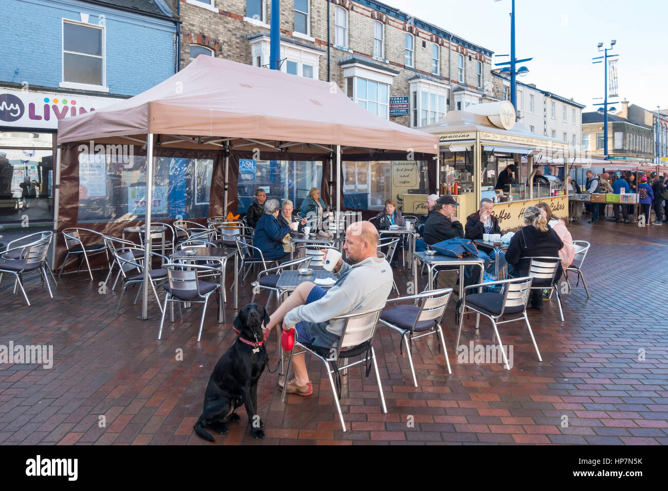 Dog sitting man seated woman hi-res stock photography and images - Alamy