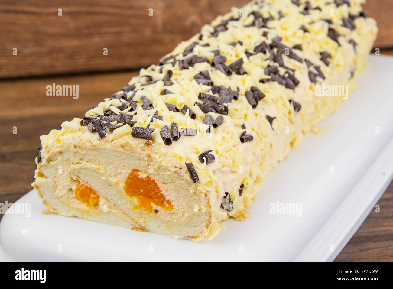 Sponge roll with whipped cream and fruit. Studio photo Stock Photo - Alamy