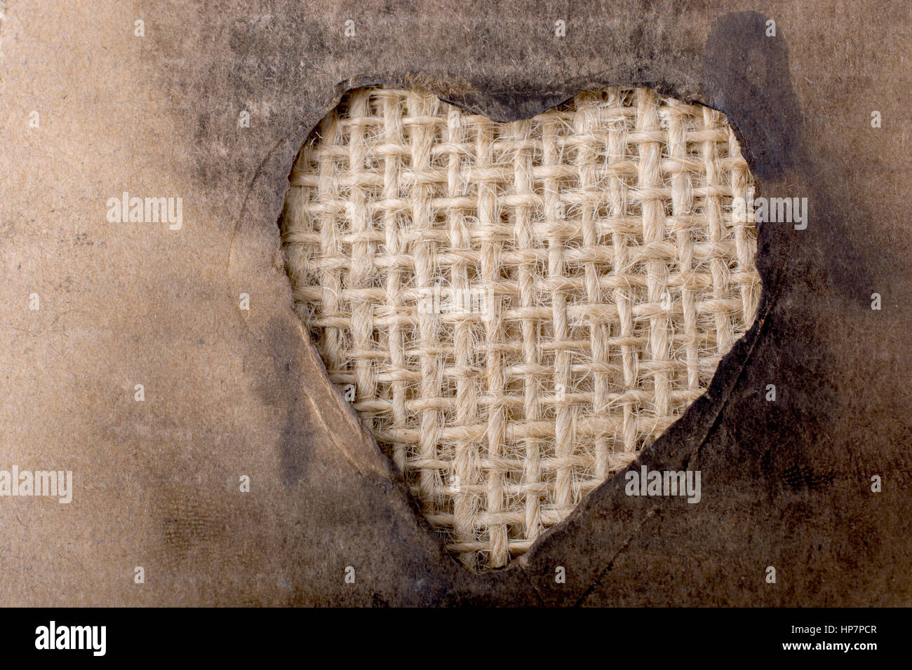 Heart shaped burnt out of a brown paper Stock Photo - Alamy