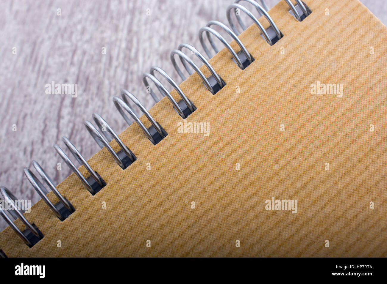 Spiral notebook placed on a grey background Stock Photo - Alamy
