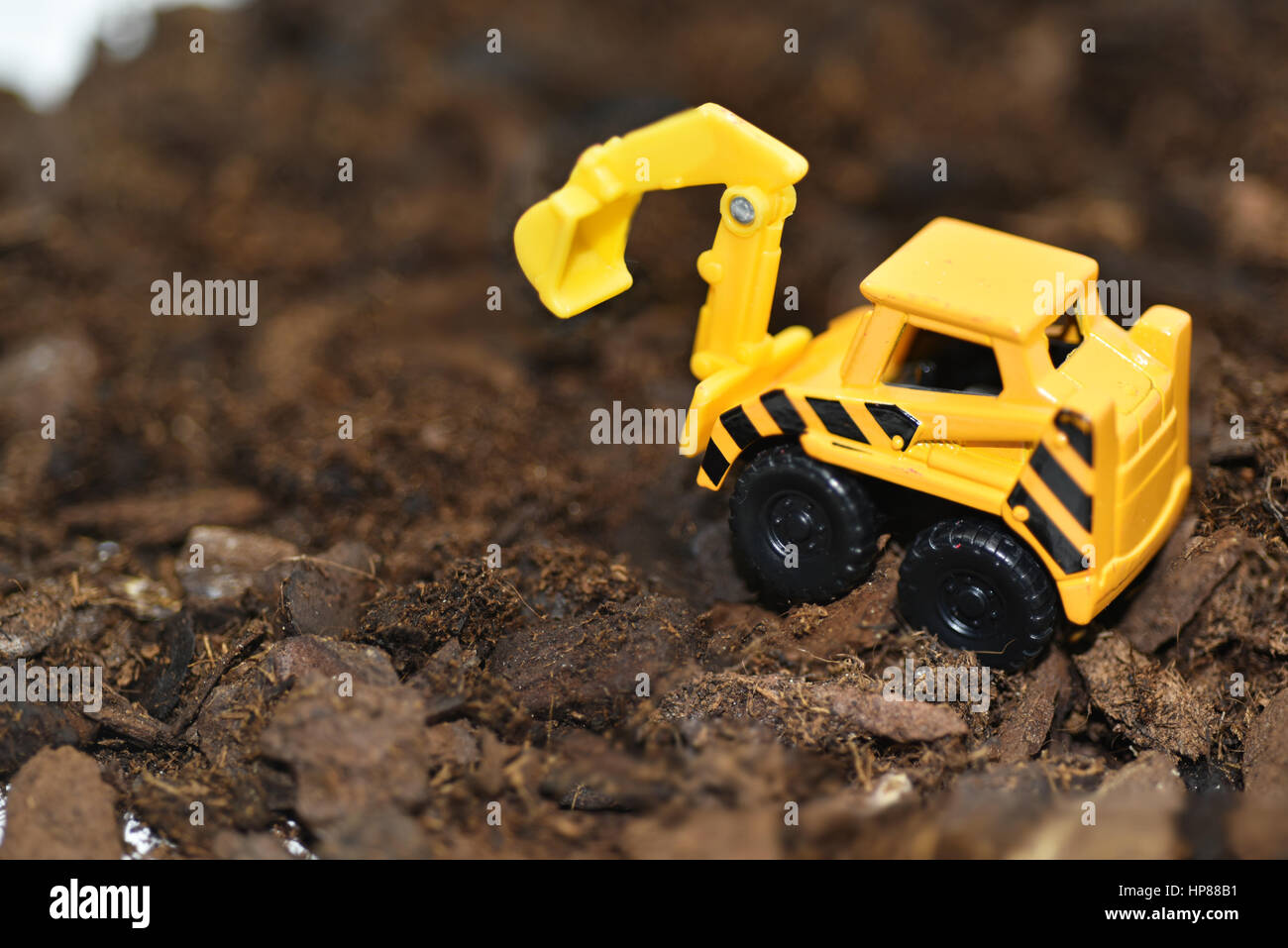 Small decorative excavator on ground. Macro abstract photo Stock Photo ...