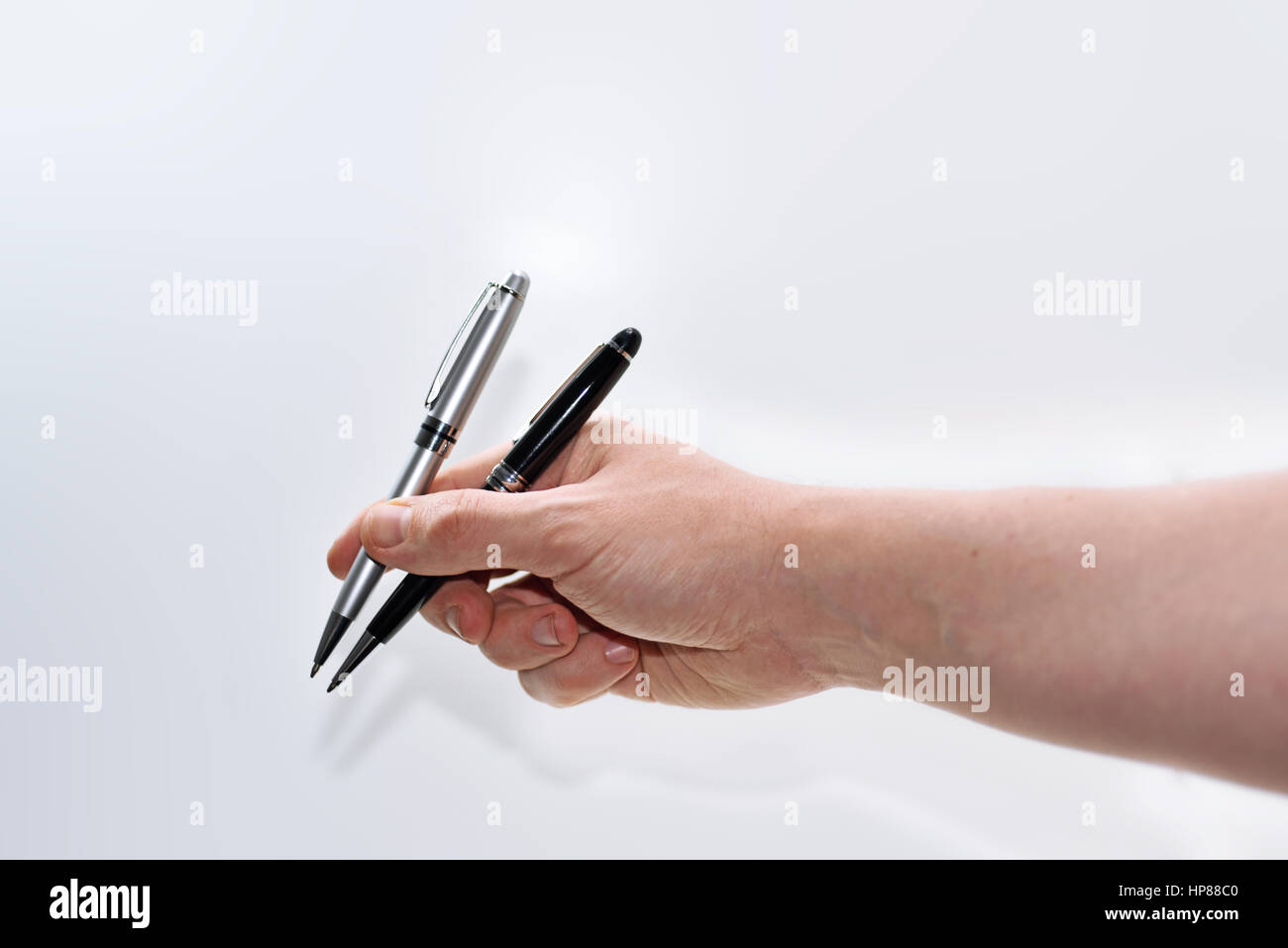 Two pans in mans hand. Isolated on white background Stock Photo - Alamy