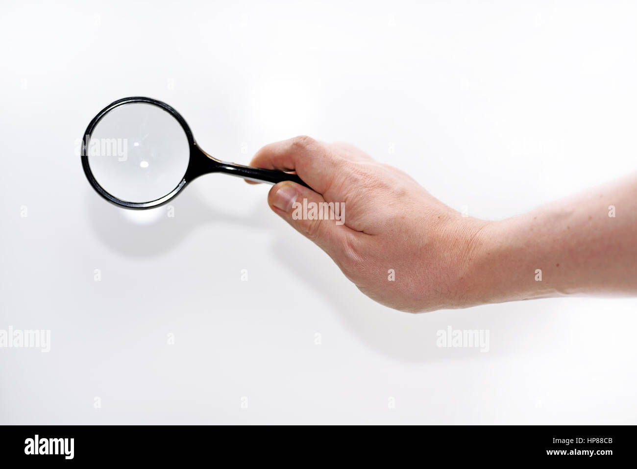 Mans hand with magnifying glass. Isolated on white background Stock ...