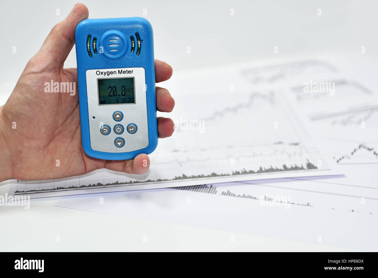 Mans hand with Oxygen meter. Abstract photo with documents Stock Photo ...