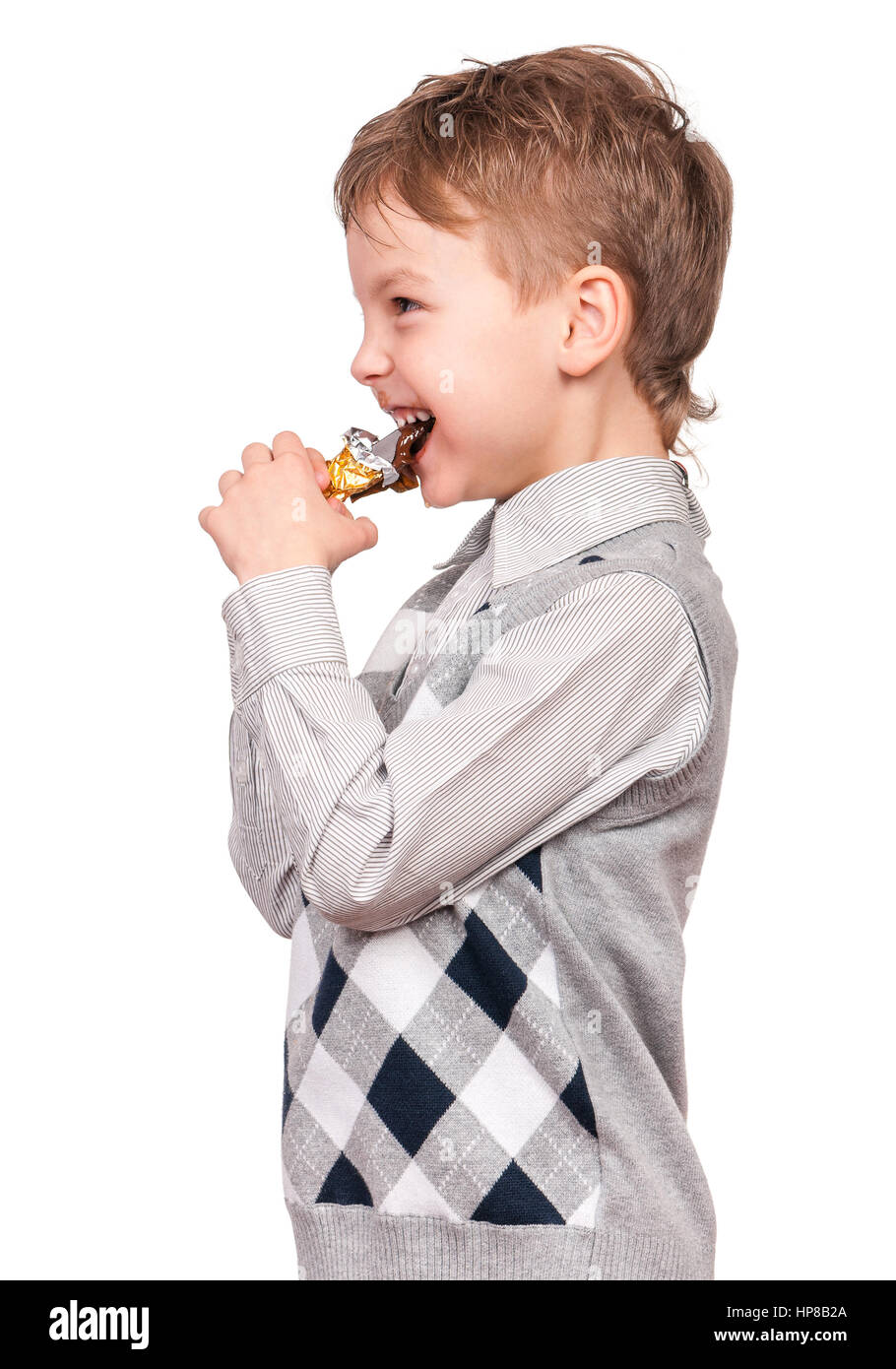 Funny little boy eating chocolate. He is smudged with chocolate. Child ...