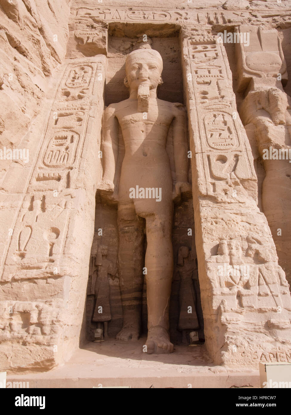 A standing statue of Ramses II outside the small temple in honour of ...