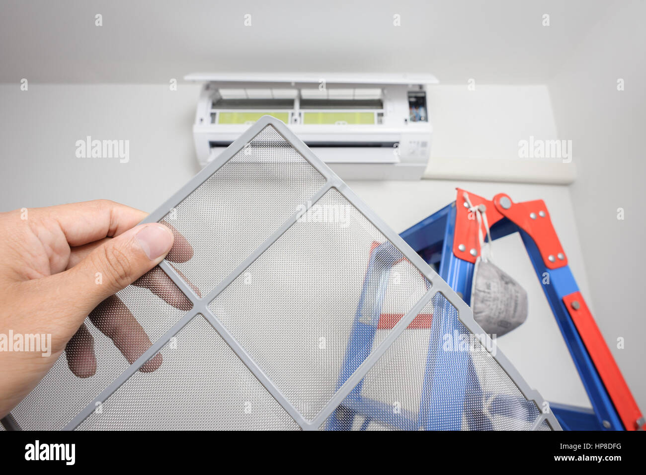 a man showing clean air filter after cleaning Stock Photo - Alamy