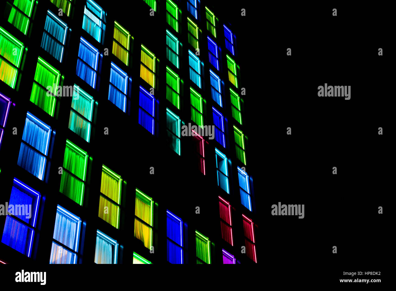 Colored windows texture. Windows illuminated by neon lights background ...