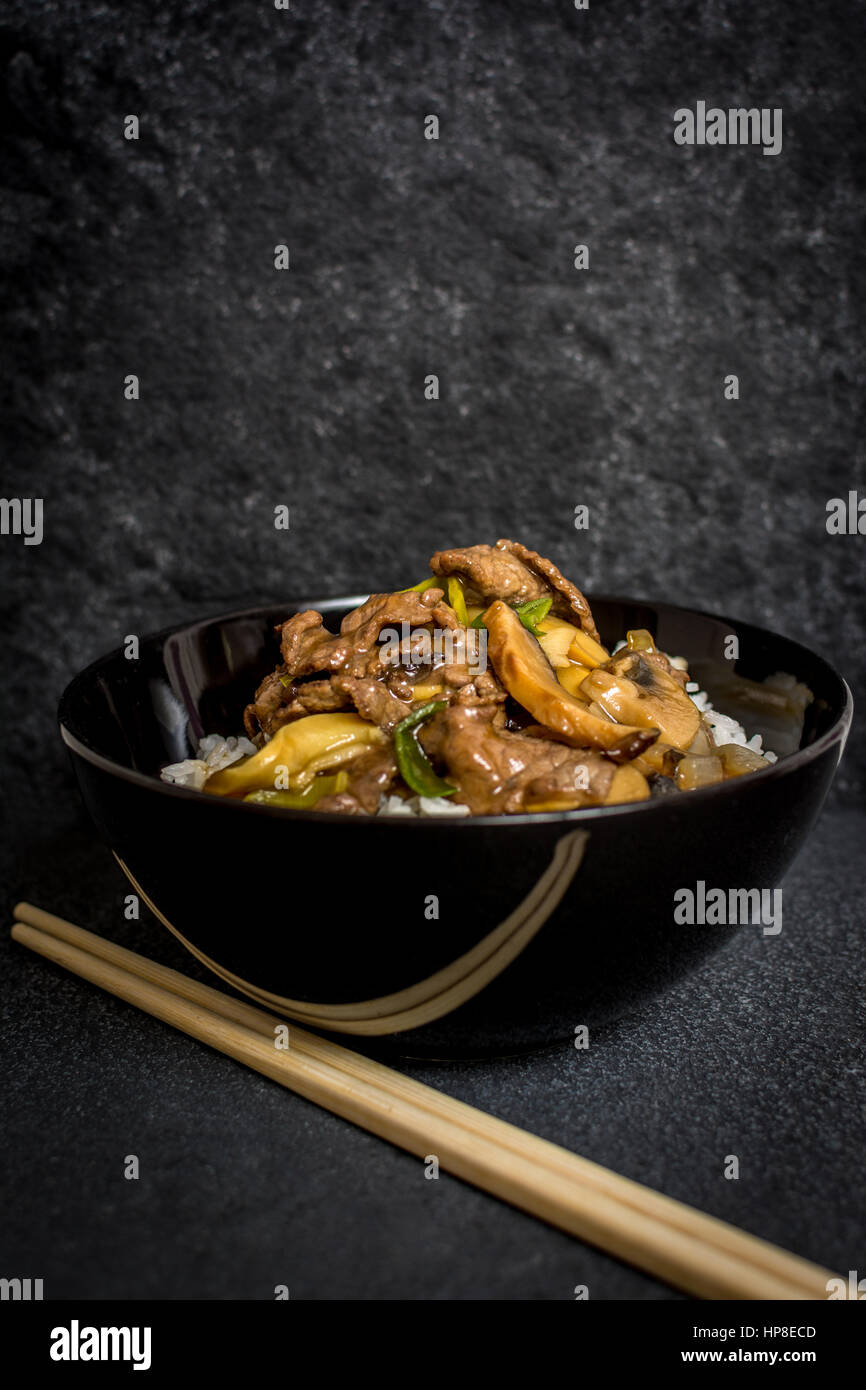 Asian rice with beef meat and vegetagles on dark background Stock Photo ...