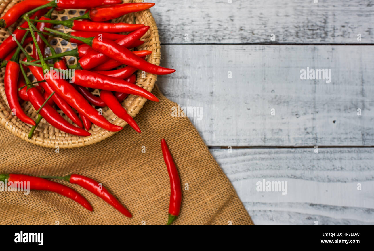 Hot and spicy red chilli on wood table background Stock Photo - Alamy