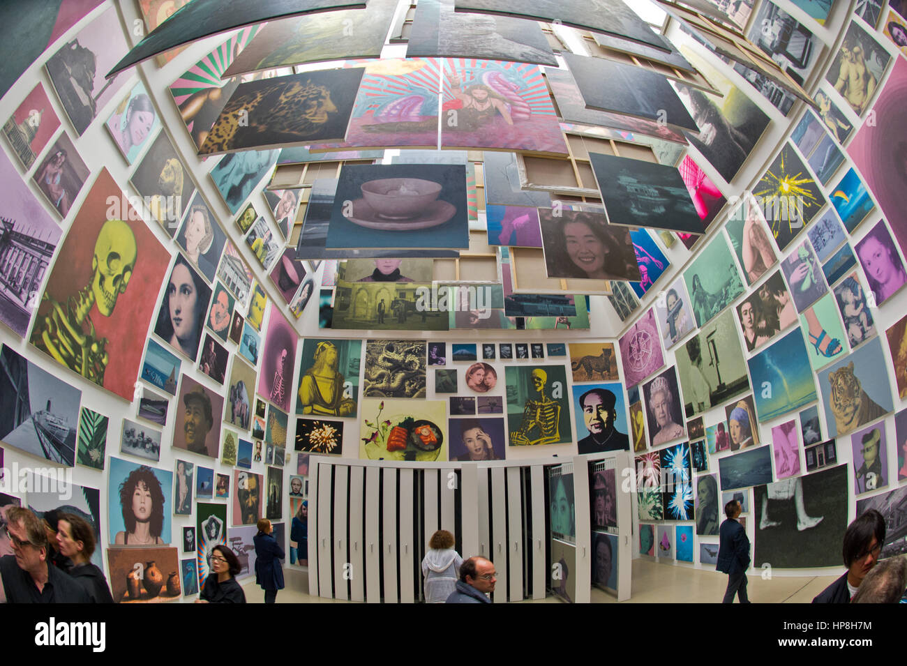 Visitors look at hundreds of pictures in the installation room called ...