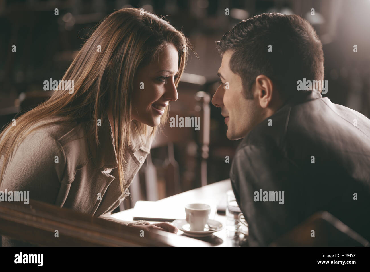 Romantic couple at the bar staring at each other's eyes Stock Photo - Alamy