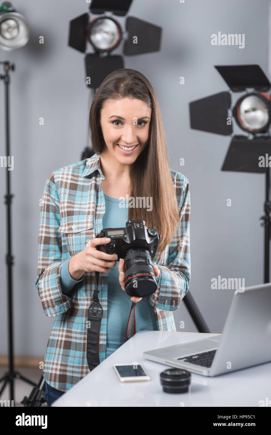 Female photographer working in her professional photo studio with a ...
