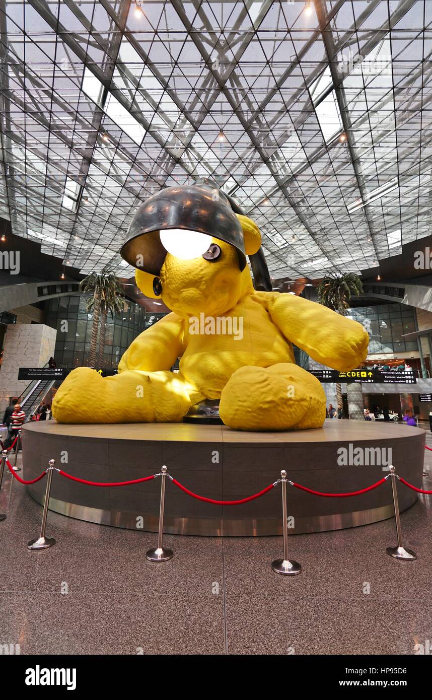 A canary yellow lamp teddy bear sculpture in the middle of the terminal ...