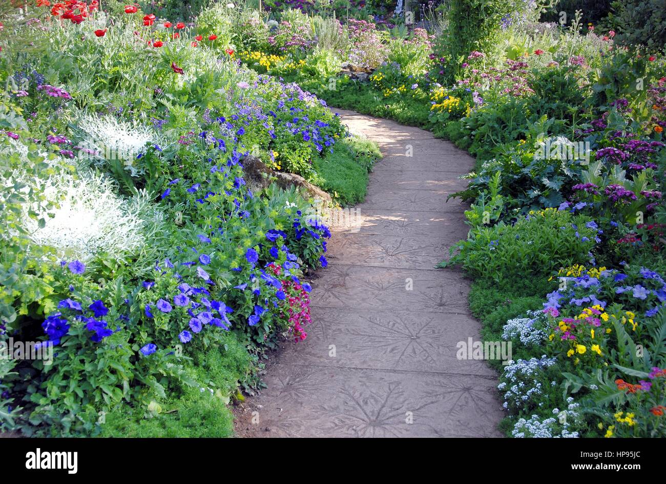 The path winding in flower garden Stock Photo - Alamy