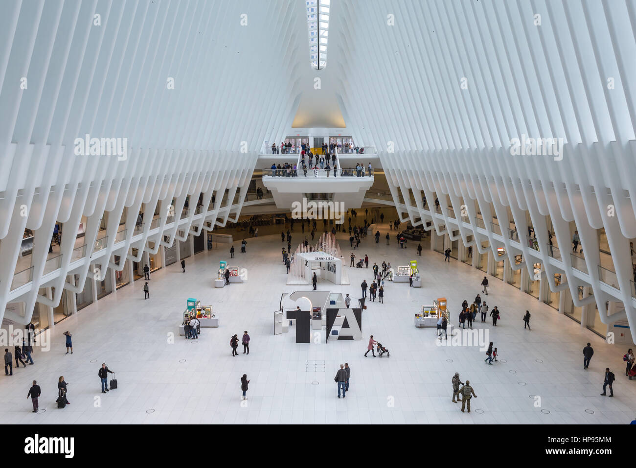 Shoppers and tourists enjoy the view inside the Oculus and stores in ...