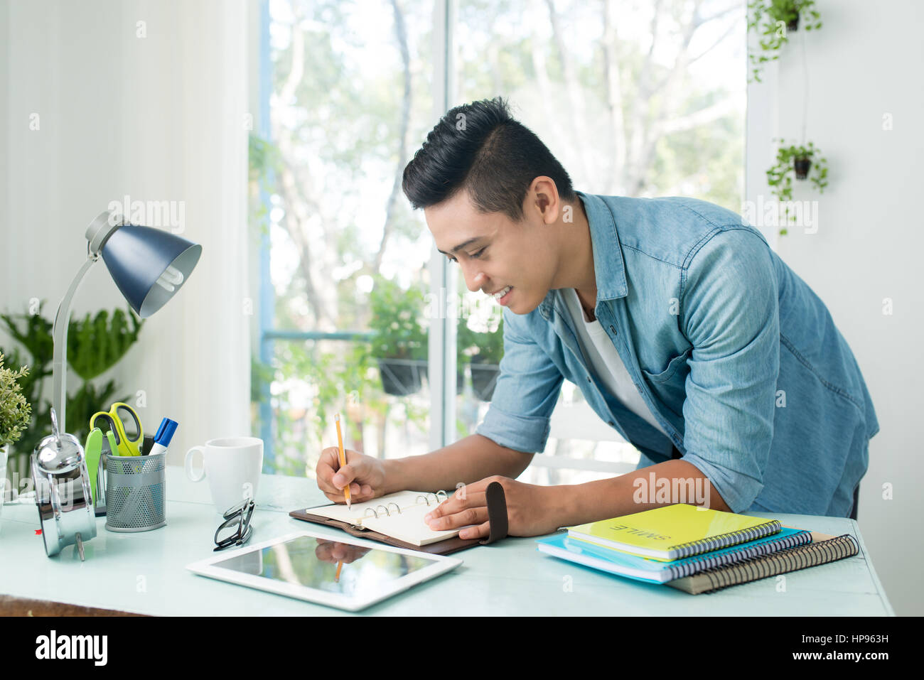 Student doing homework and preparing exam at home Stock Photo - Alamy