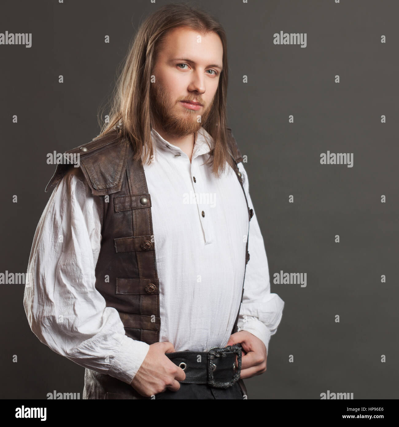 Handsome male Steam punk in a leather vest. Retro man portrait over ...