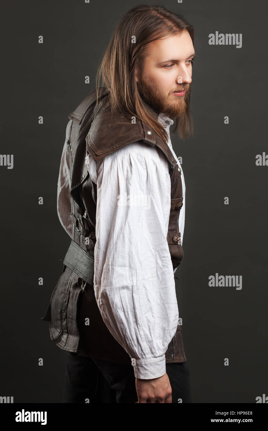 Handsome male Steam punk in a leather vest. Retro man portrait over ...