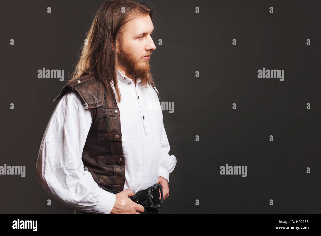 Handsome male Steam punk in a leather vest. Retro man portrait over ...