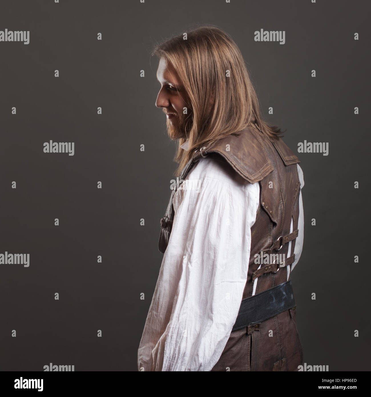 Handsome male Steam punk in a leather vest. Retro man portrait over ...